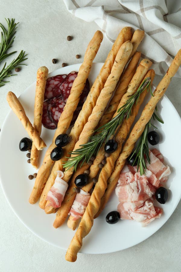 Plate with Grissini and Snacks on White Textured Background Stock Photo ...