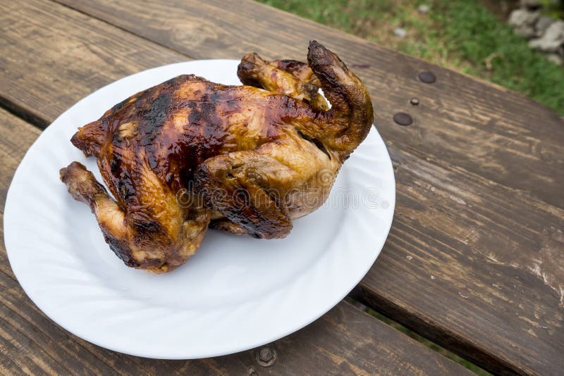 A Plate of Lechon Manok, or Roasted Chicken Served Outside at a Bench ...