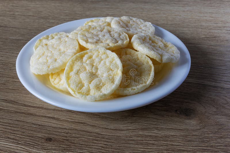 A Plate of Many Round Rice Chips with Cheese Flavor on the Table Stock ...
