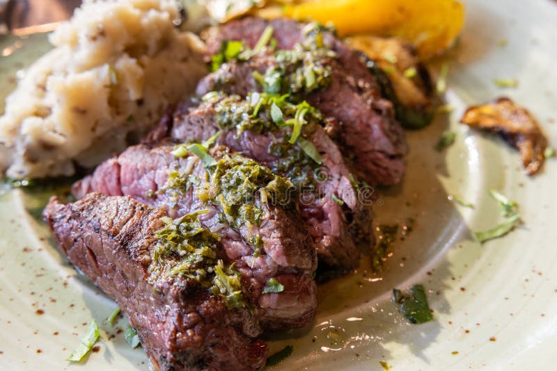 A Plate of Meat with a Side of Mashed Potatoes and Vegetables Stock ...