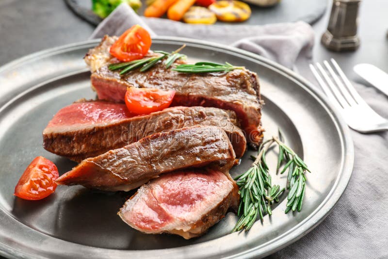 Plate with Meat and Vegetable Garnish on Table Stock Photo - Image of ...
