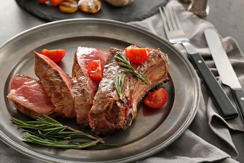 Plate with Meat and Vegetable Garnish on Table Stock Image - Image of ...