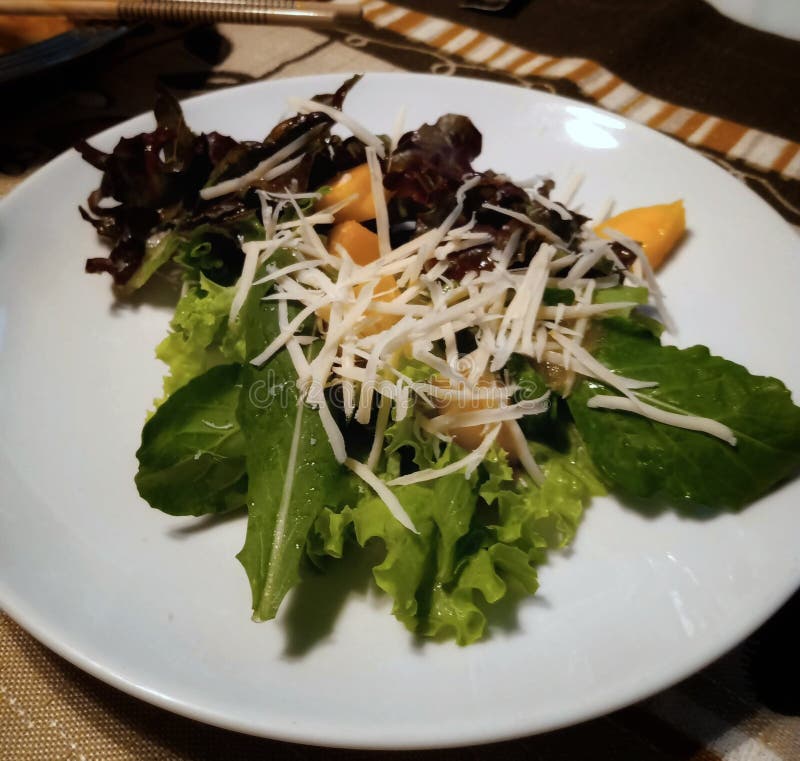 A Plate of Mixed Green Leaf Salad with Mango and Grated Cheese Stock ...