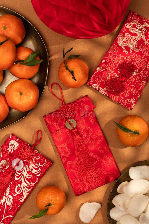 A Plate of Oranges and Red Gift Envelopes on a Beige Table, Symbolizing ...