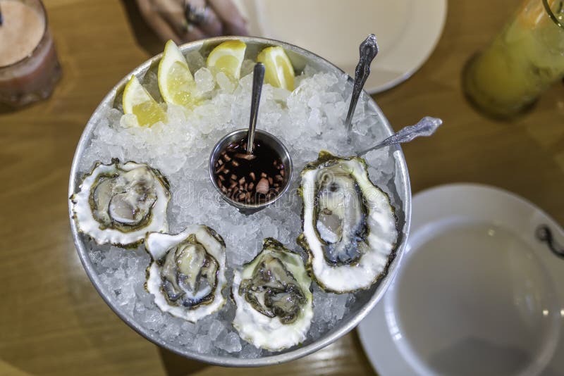 A Plate with Oysters on Ice, a Still Life with Lemon Stands on the ...