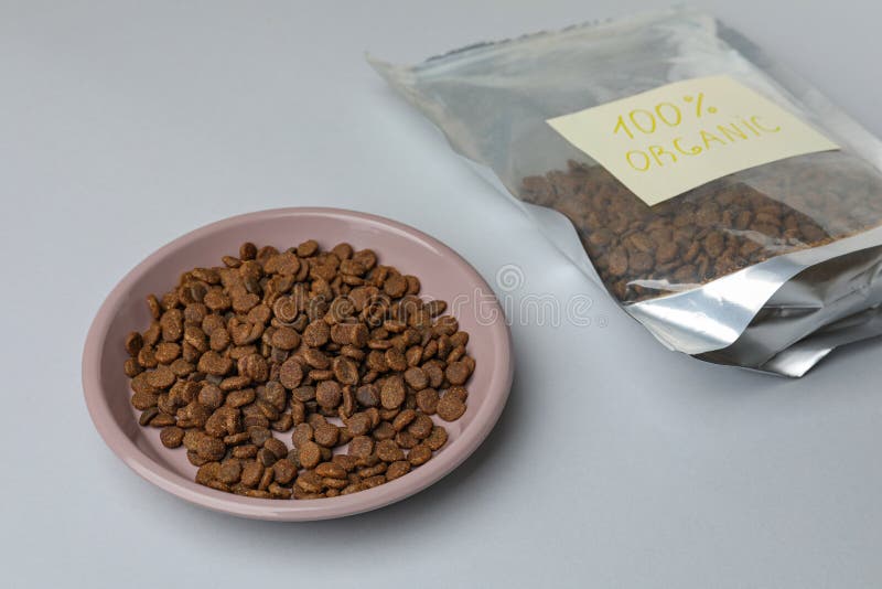 Plate and Pack of Organic Kibble on Light Background Stock Image ...