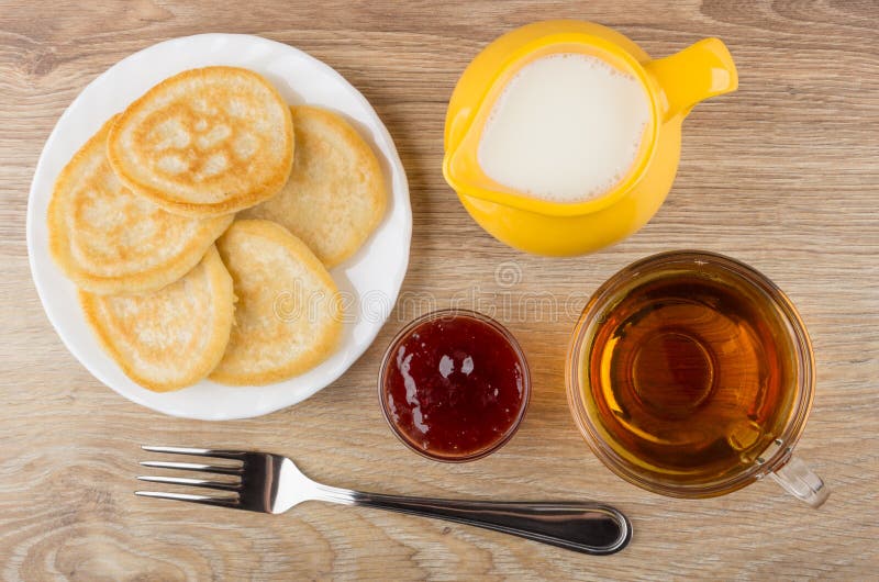 Plate with Pancakes, Yellow Jug with Milk, Cup of Tea Stock Photo ...