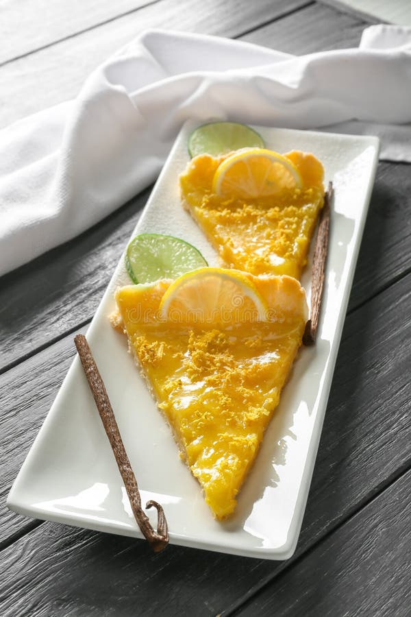 Plate with Pieces of Delicious Lemon Pie on Wooden Table Stock Photo ...