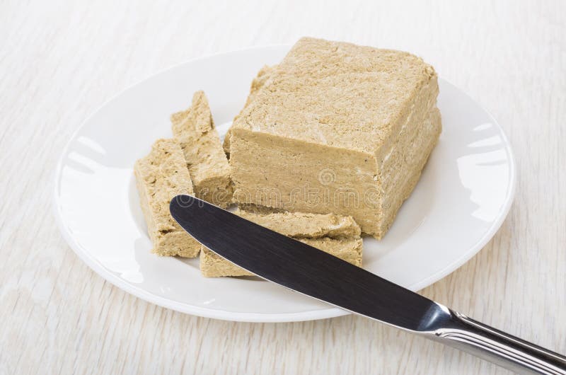 Plate with Pieces of Halva and Knife on Table Stock Photo - Image of ...