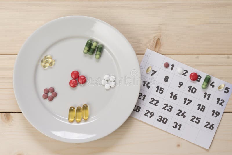 Plate with Pills and a Calendar Stock Photo - Image of medical ...
