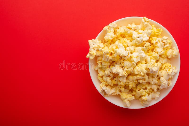 Plate with Popcorn on Yellow and Red Background. Layout. Top View Stock ...