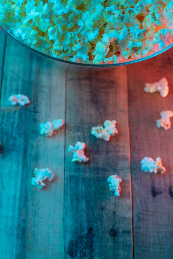 A Plate of Popcorn on a Wooden Texture. Concept of Film Viewing ...