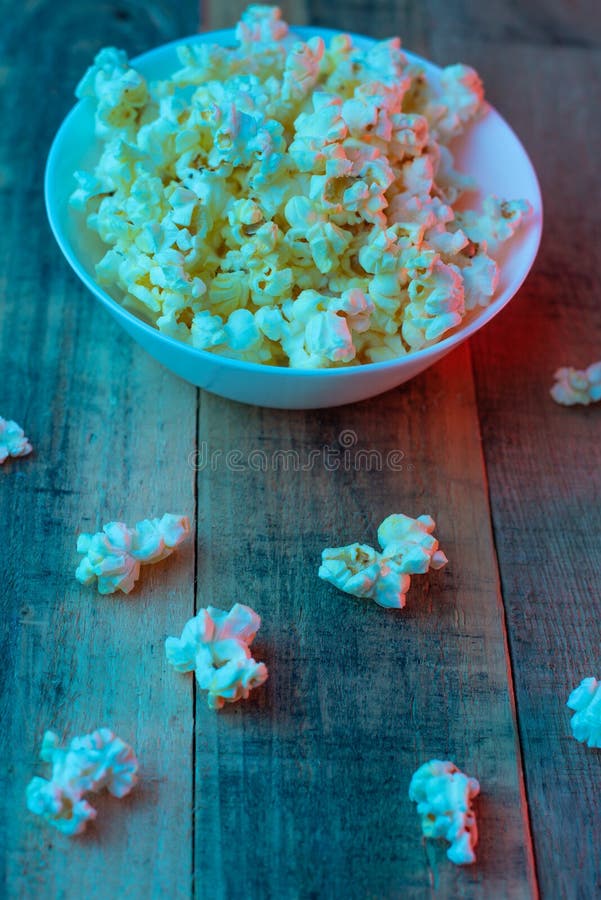 A Plate of Popcorn on a Wooden Texture. Concept of Film Viewing ...