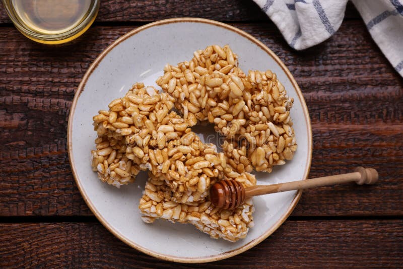 Plate with Puffed Rice Bars Kozinaki on Wooden Table, Flat Lay Stock ...