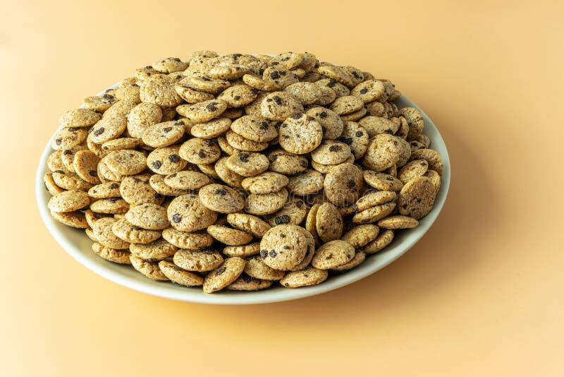 A Plate of Round Shaped Chocolate Flavored Flakes on a White Background ...