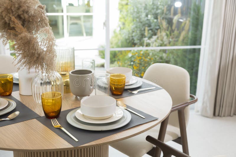 Plate Setting on Round Table in Modern Style Dining Room Interior of ...