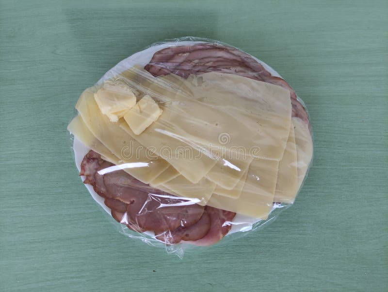 Plate with Sliced Ham and Cheese, Covered with Cling Film Stock Photo ...