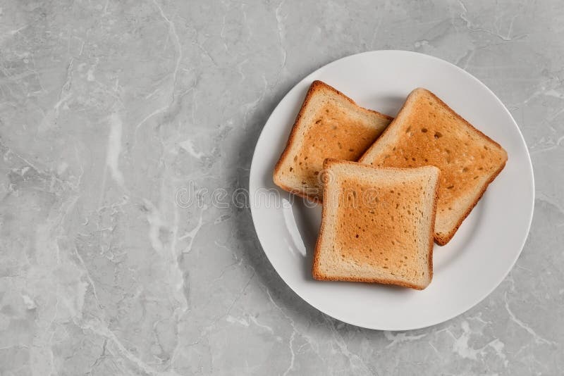 Plate with Slices of Delicious Toasted Bread on Gray Marble Table, Top ...