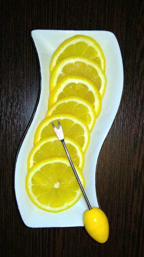 On Plate are Slices of Lemon and a Fork in the Form of a Lemon Stock ...