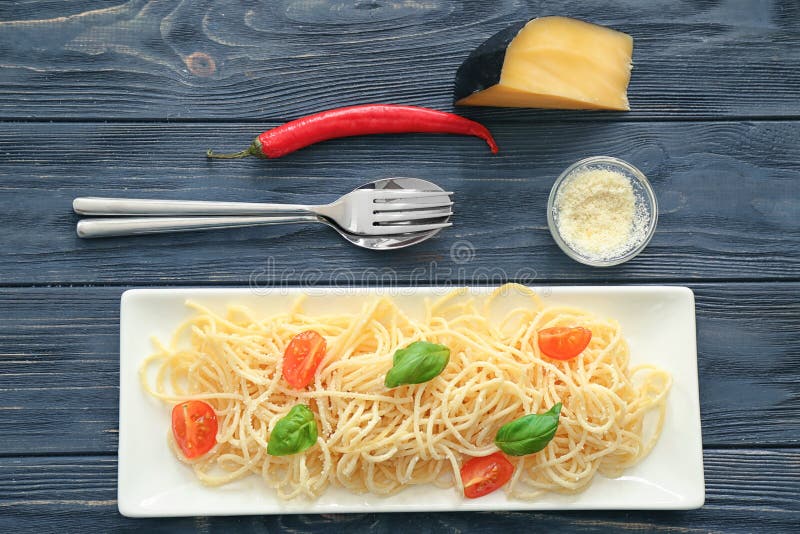 Plate with Spaghetti and Tomatoes on Table. Delicious Pasta Recipes ...