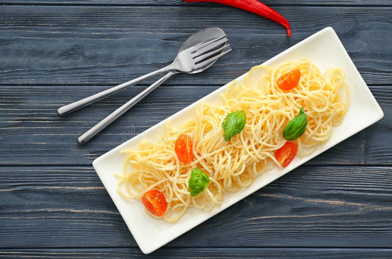 Plate with Spaghetti and Tomatoes on Table. Delicious Pasta Recipes ...