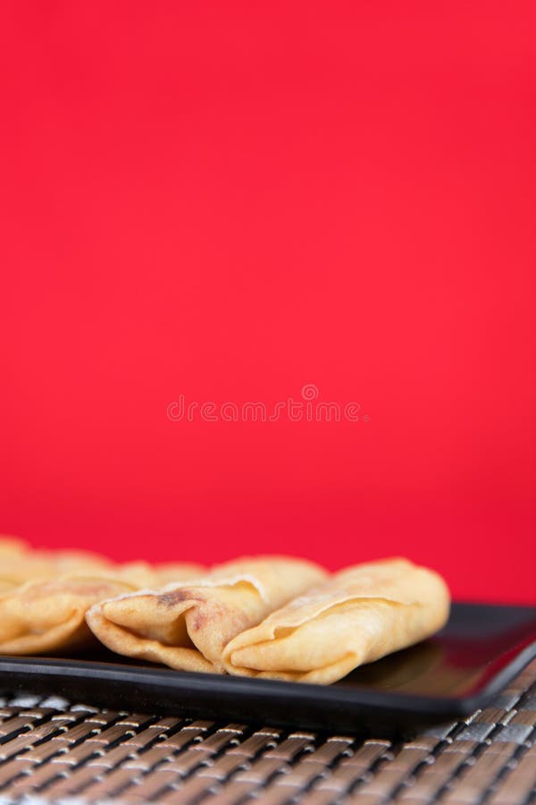 A Plate of Spring Rolls on the Red Background Stock Photo - Image of ...