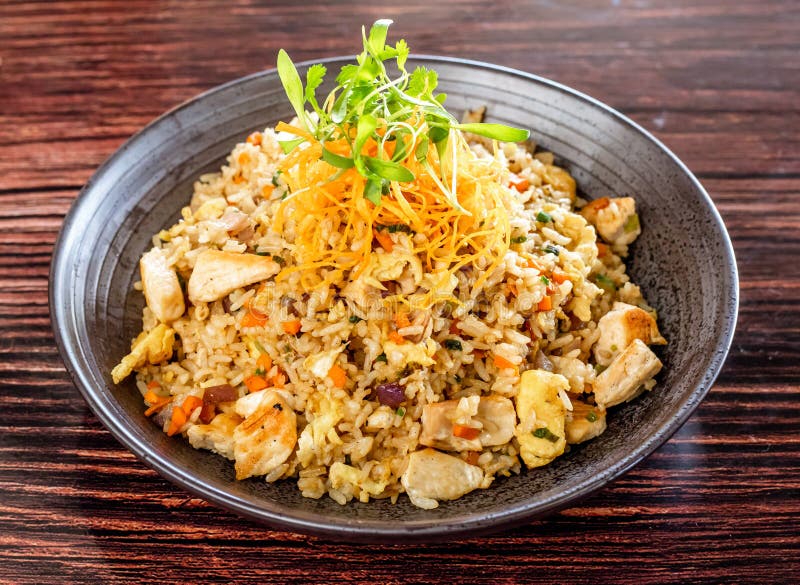 Plate of Tasty Rice and Chicken Dish on Wooden Table Stock Image ...