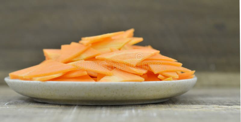 Plate with Triangle Slices Carrots on Wooden Rustic Stock Photo - Image ...