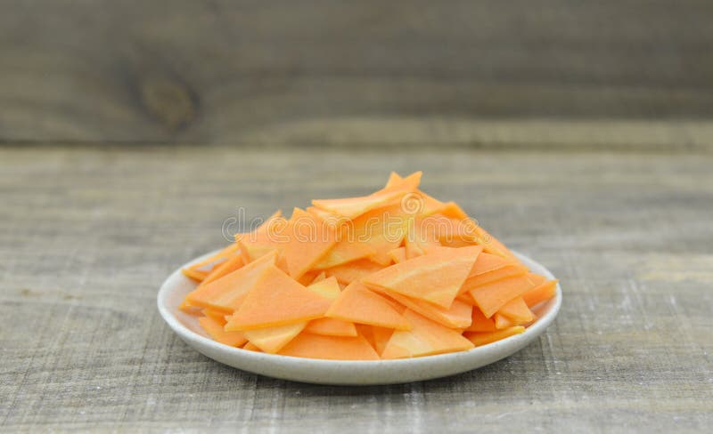 Plate with Triangle Slices Carrots on Wooden Rustic Stock Image - Image ...