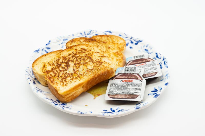 A Plate with Two Pieces of Toast and a Jar of Nutella Stock Photo ...