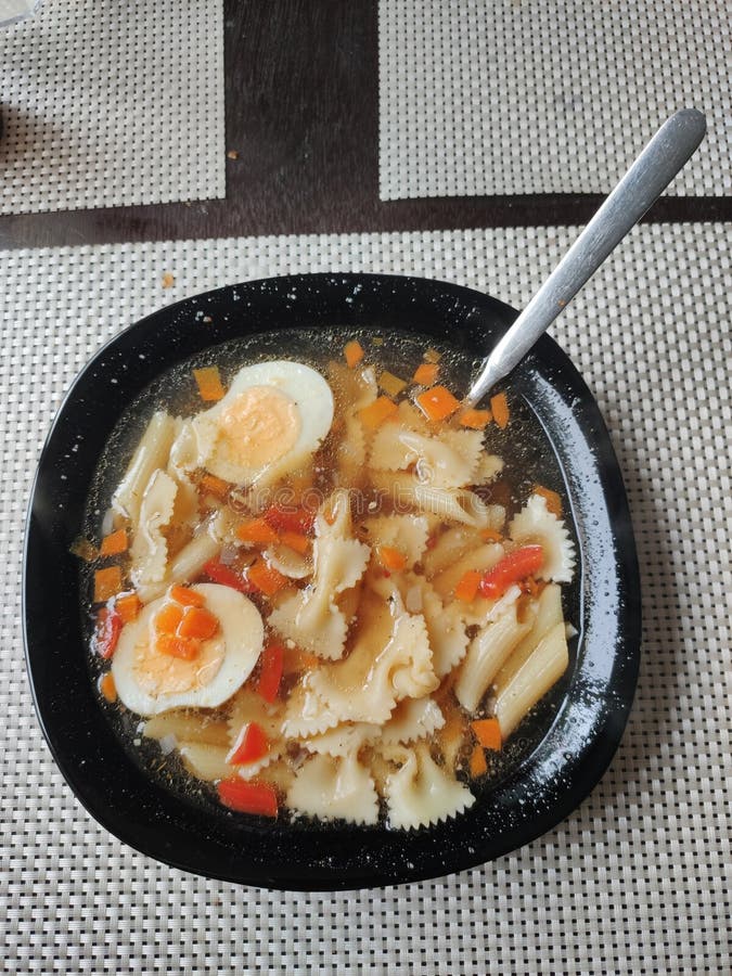 A Plate of Vegetable Soup with Butterflies Pasta on the Kitchen Table ...
