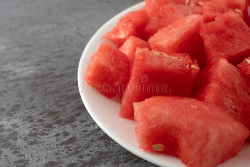 Plate of Watermelon Chunks on a Gray Mottled Table Side View Stock ...