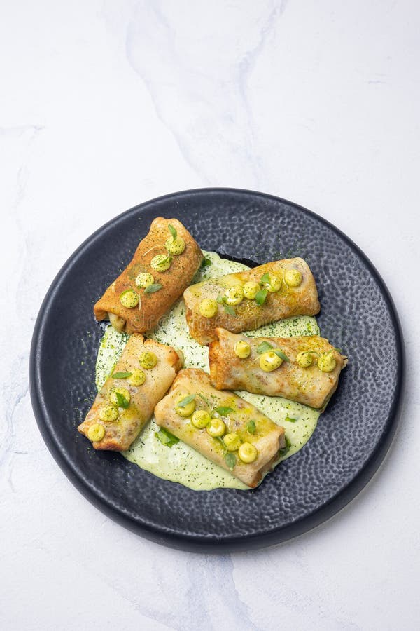 Plate of wrapped pancakes stock photo. Image of cakes - 330703410