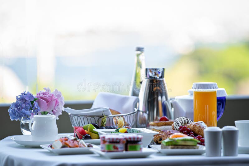 Plates with Assorted Breakfast Meal on a White Table in a Hotel Room ...