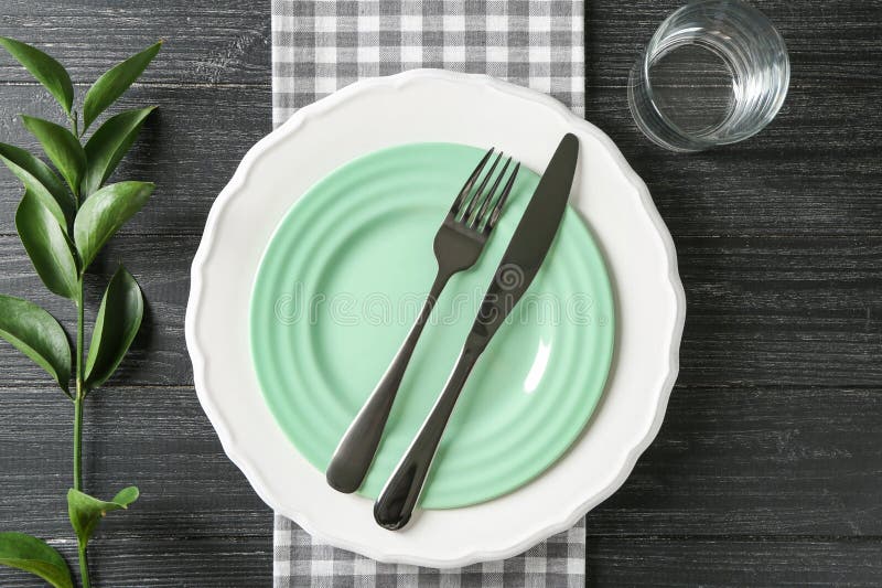 Plates with Fork and Knife on Wooden Table Stock Photo - Image of dark ...