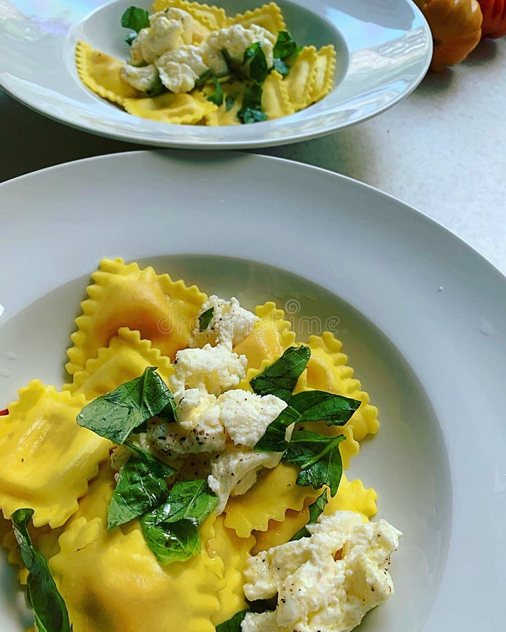 Plates with Fresh Ravioli, Shredded Mozzarella, Basil Stock Photo ...