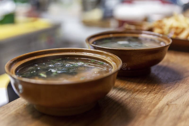 Plates with Hot Asian Soup on the Table. Close-up Stock Photo - Image ...