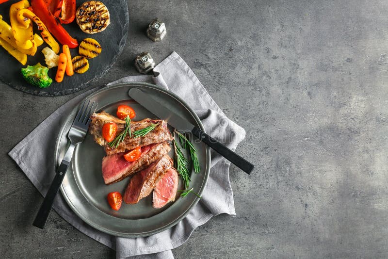 Plates with Meat and Vegetable Garnish on Table, Top View Stock Photo ...