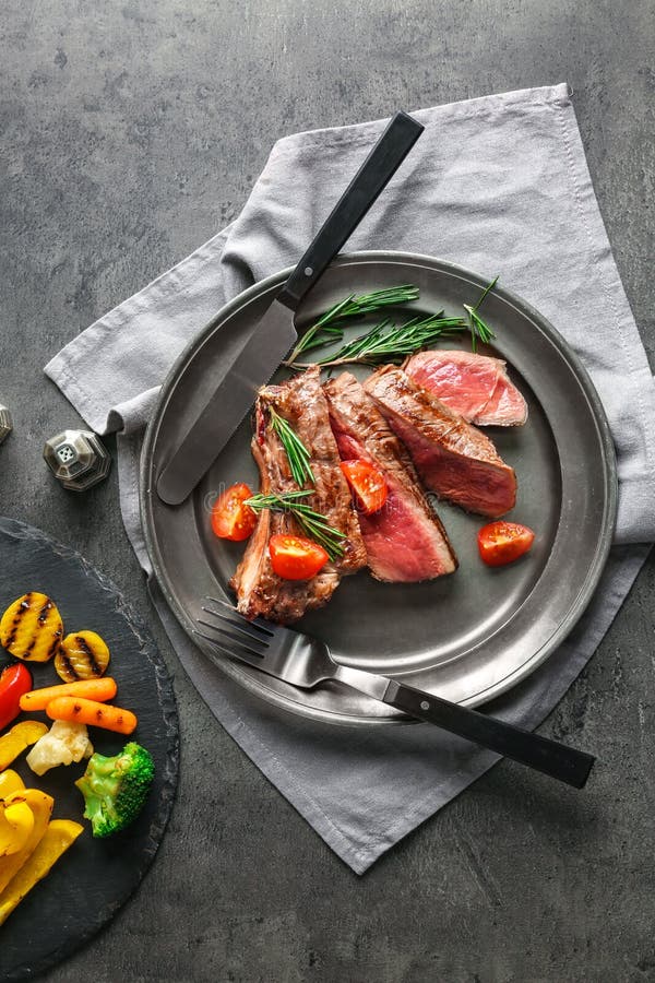 Plates with Meat and Vegetable Garnish on Table, Top View Stock Image ...