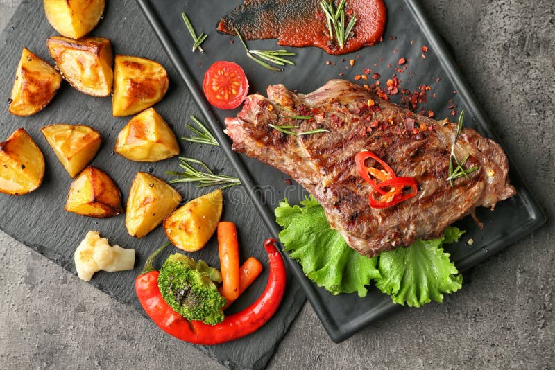 Plates with Tasty Meat and Vegetable Garnish on Grey Background, Top ...