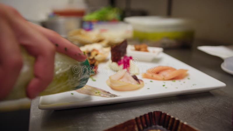 Plating of a Raw and Cooked Fish Based Appetizer in a Luxury Italian ...