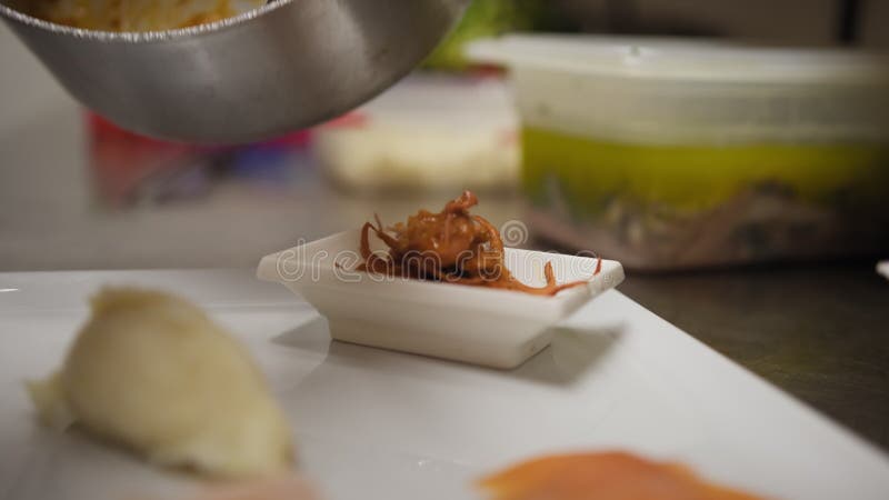 Plating of a Raw and Cooked Fish Based Appetizer in a Luxury Italian ...