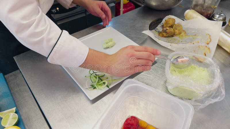 Plating of a Raw and Cooked Fish Based Appetizer in a Luxury Italian ...