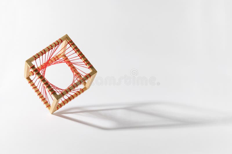 Platonic Solid Wooden Cube with Red Thread on Edge Over White ...