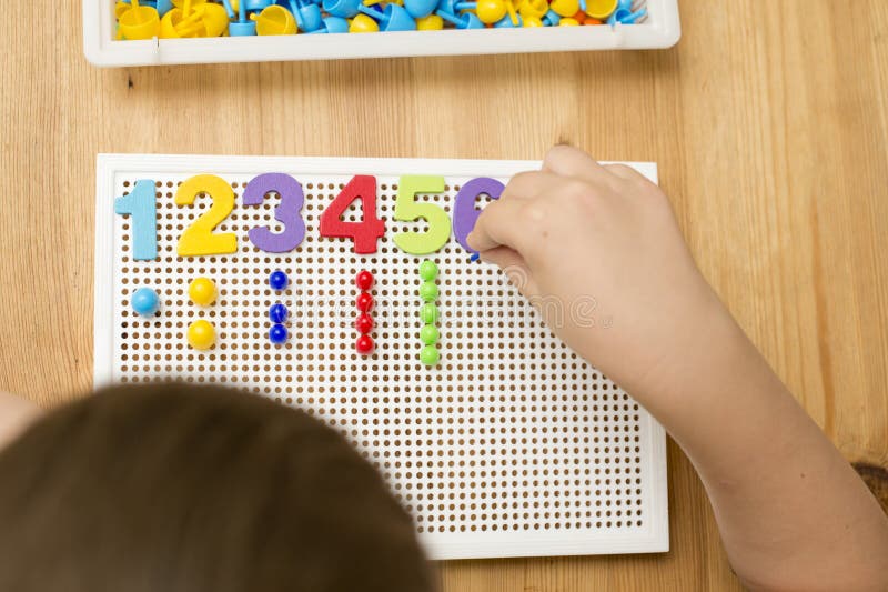 By Provided Numbers Boy Inserting Pins. Stock Image - Image of ...