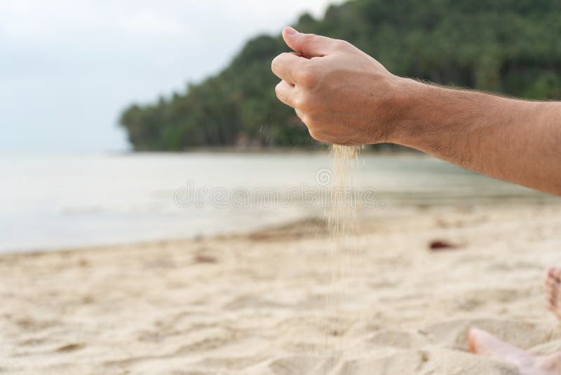 Play with Sand on the Beach. Sand is Poured from the Hands, Against the ...