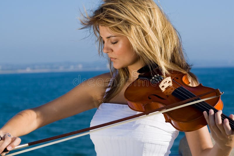 Play violin stock image. Image of happiness, beach, elegance - 7293967