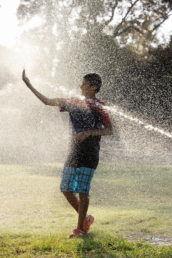 Play with water jets stock image. Image of teenager - 238365531