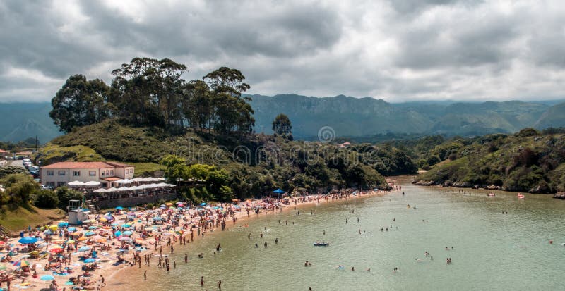 Playa De Poo Surrounded by People and Hills Covered in Greenery Under a ...