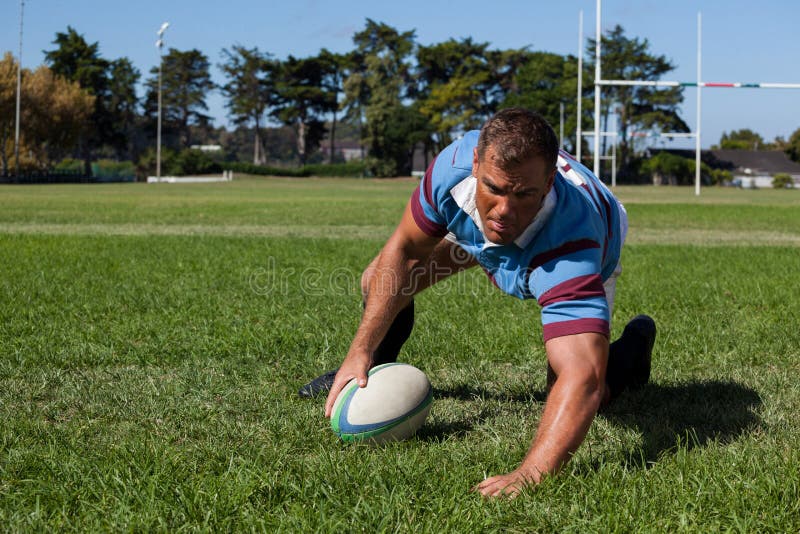 Player Holding Ball while Playing Rugby on Field Stock Photo - Image of ...